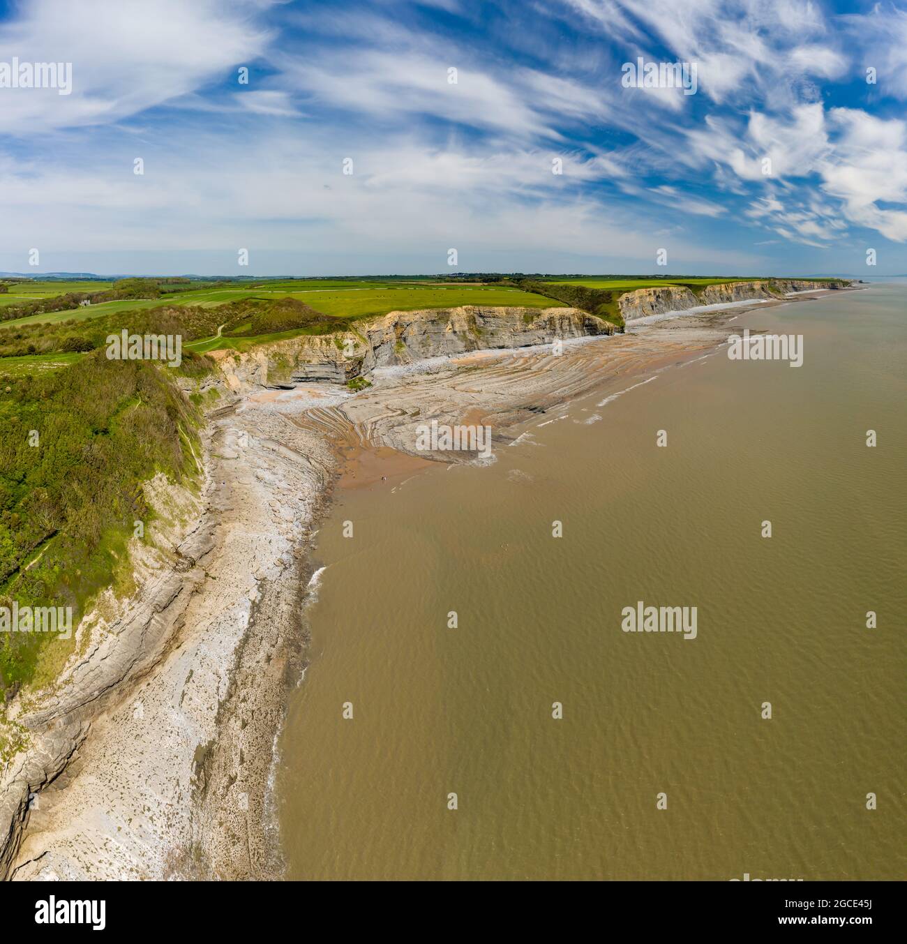 Aerial view of sea cliffs, rock formations and a sandy beach ...