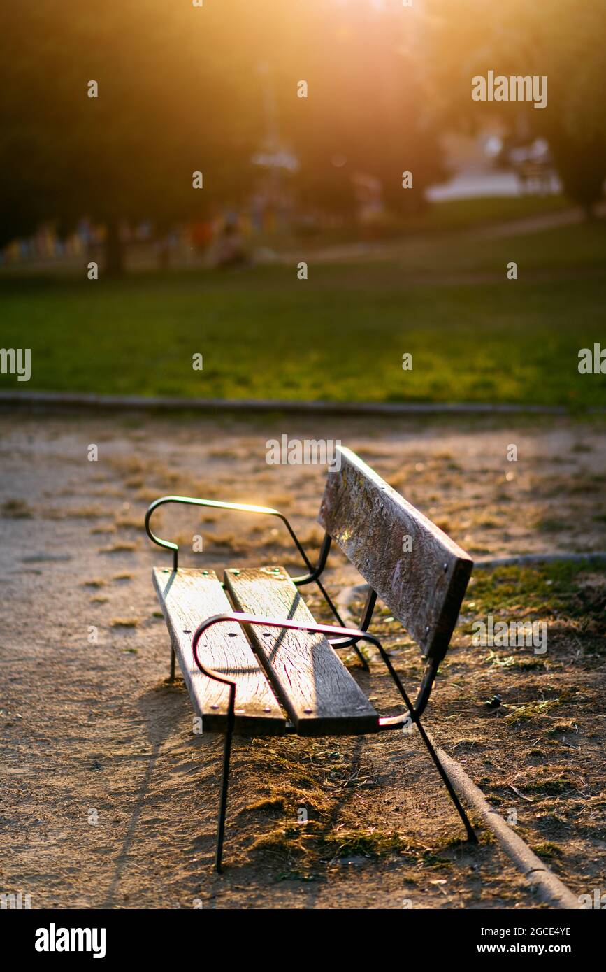 one bench in an urban park Stock Photo - Alamy