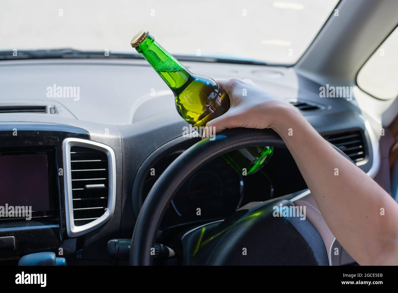 Hand holding beer bottle driving hi-res stock photography and images ...