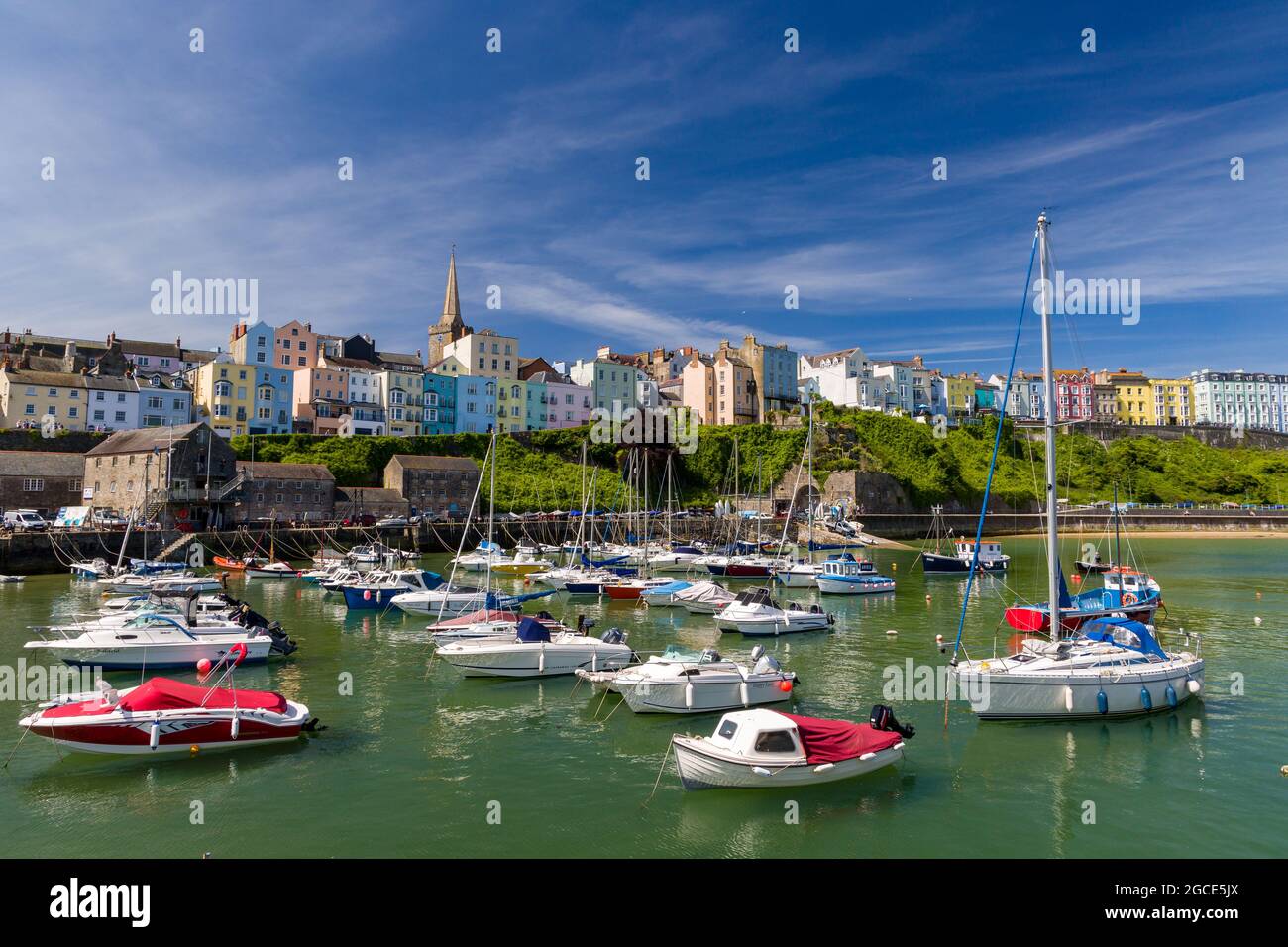 TENBY, WALES - JULY 16 2021: Colourful boats and buildings around the ...
