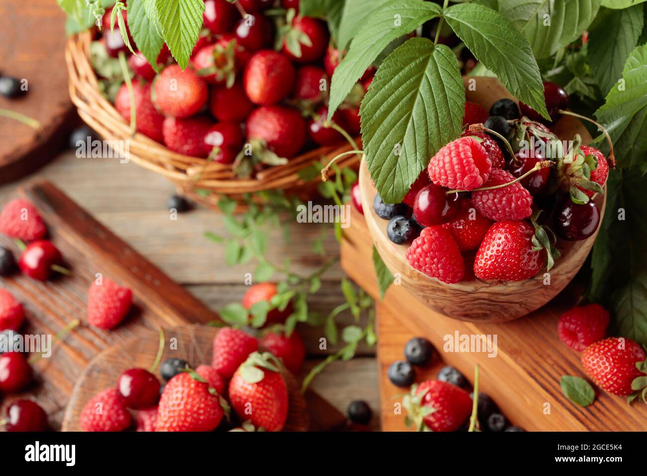 Assorted fresh berries with leaves. Strawberries, raspberries ...