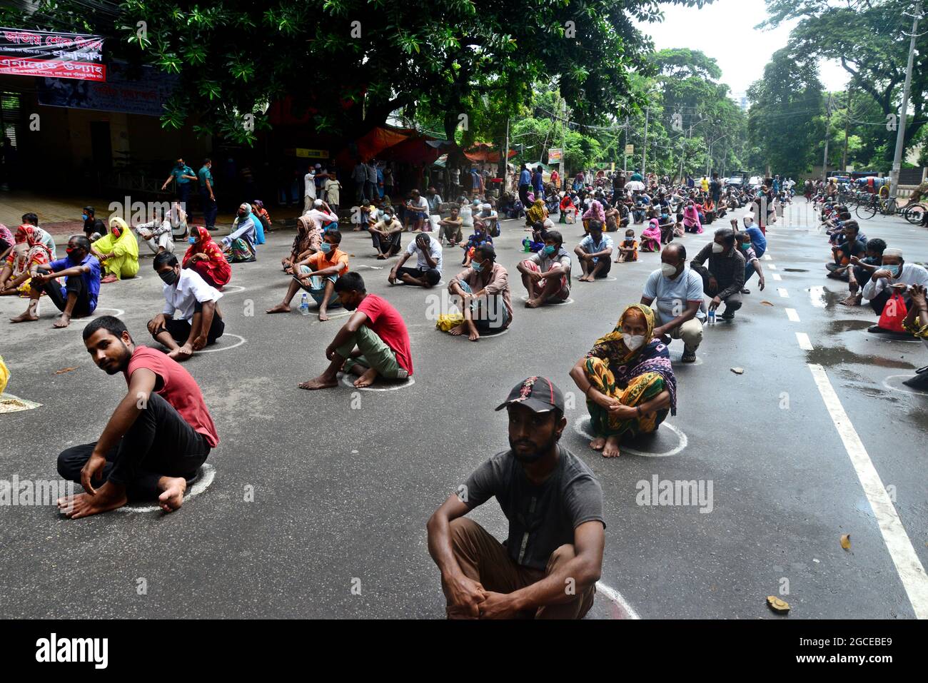 Poor people queue sit waits for receive food from Dhaka Metropolitan ...