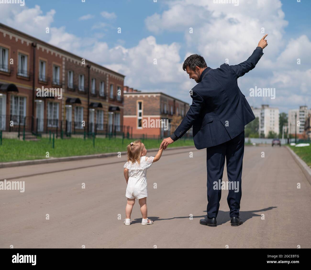 Back view man holding child hand hi-res stock photography and images ...