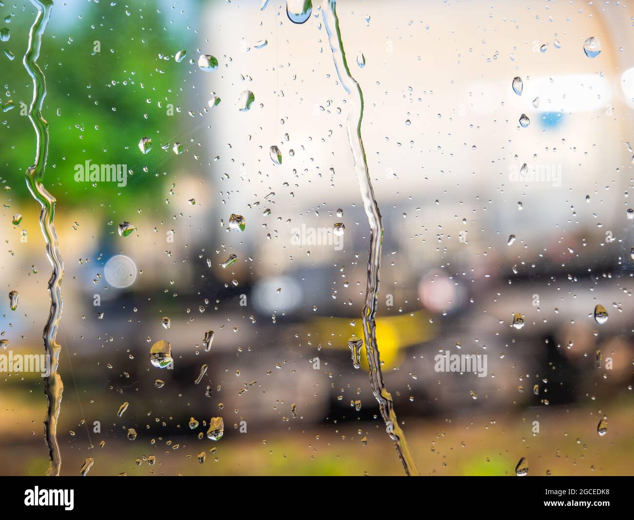 Close up with rain drops or water drops on the glass window. Draining ...