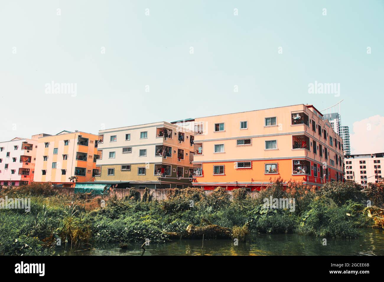 The rows of apartment buildings with bright colored walls in Bangkok ...