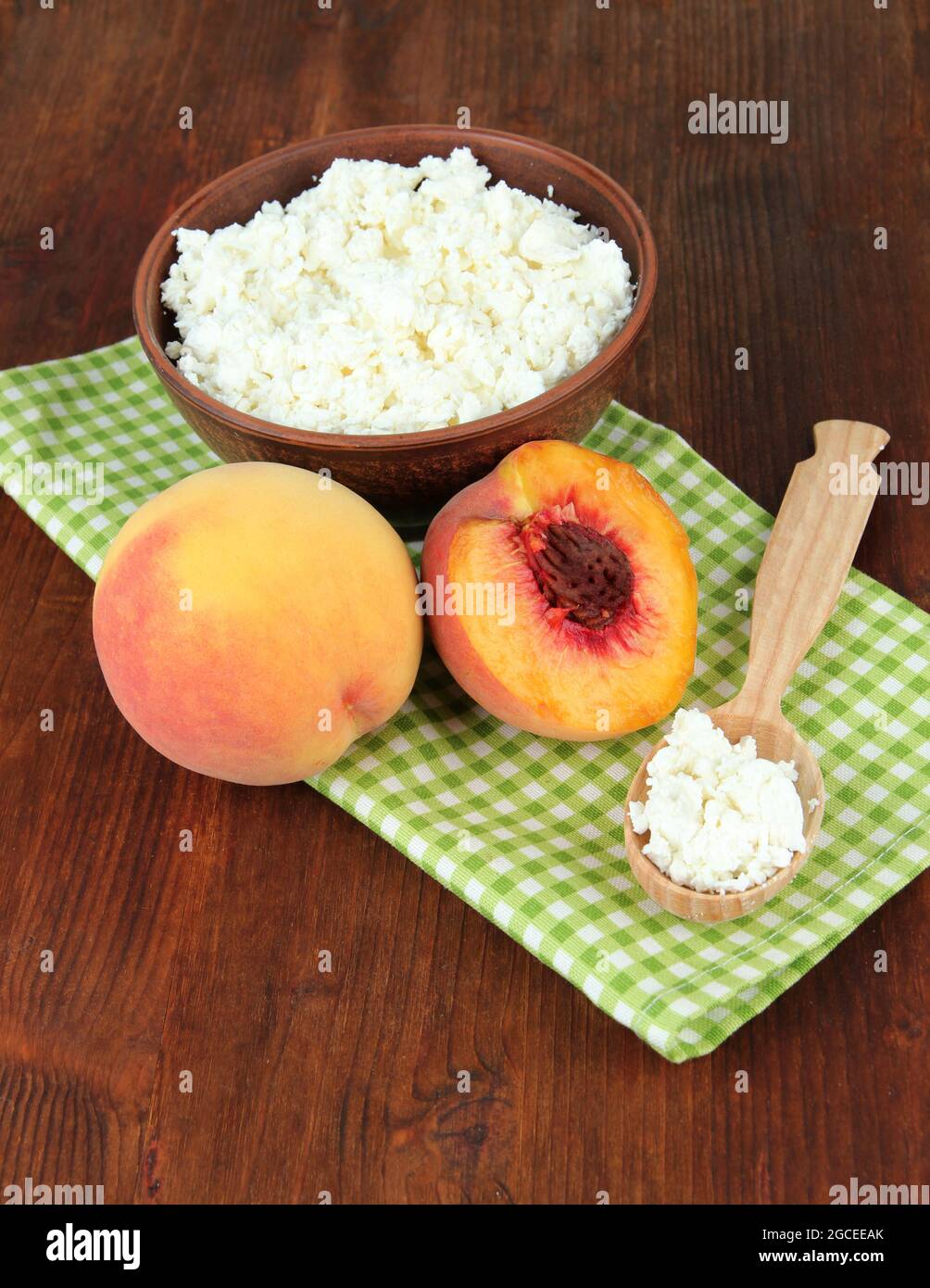 Sour cheese and fresh peaches,on wooden table background Stock Photo ...