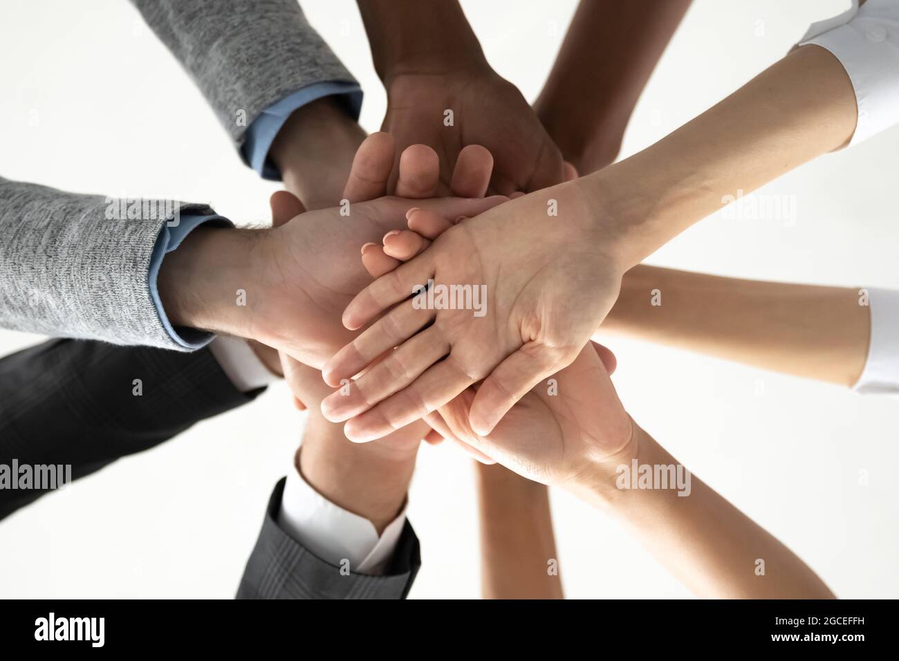 Close up of diverse people stack hands for shared success Stock Photo ...
