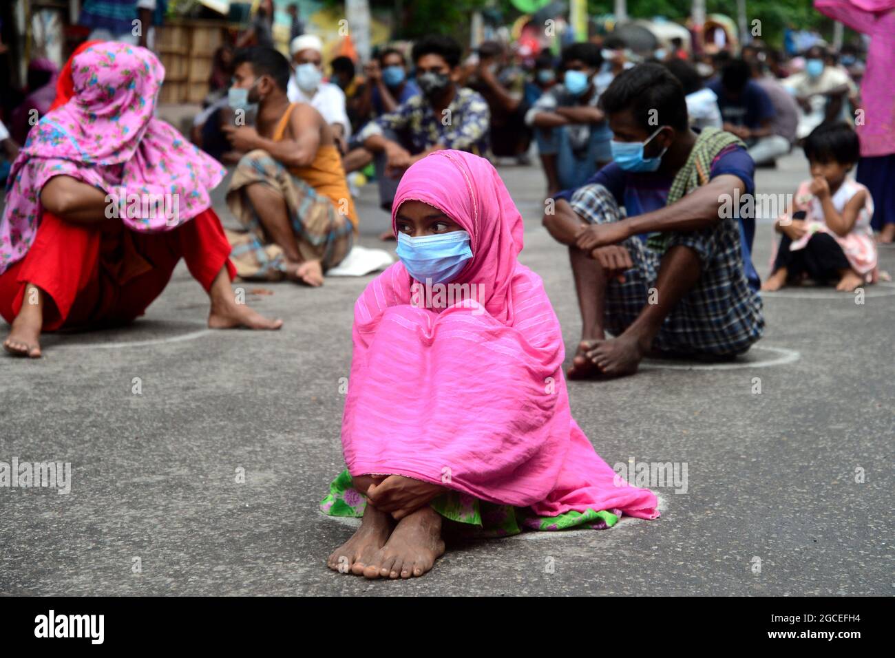 Poor people queue sit waits for receive food from Dhaka Metropolitan ...