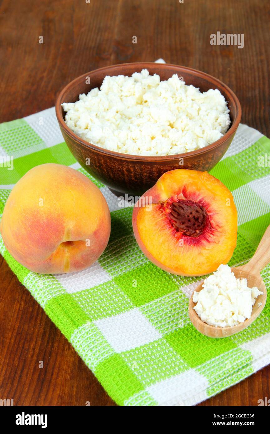 Sour cheese and fresh peaches,on wooden table background Stock Photo ...