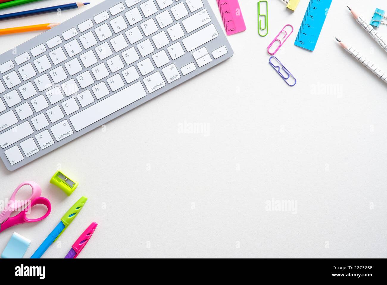 Flat lay school supplies and computer keyboard on white background ...