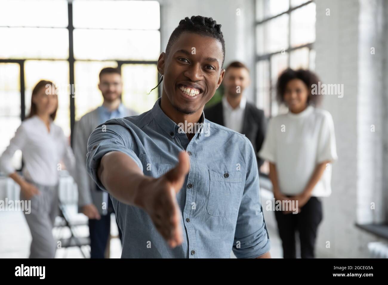 Portrait of smiling African American man stretch hand for handshake ...