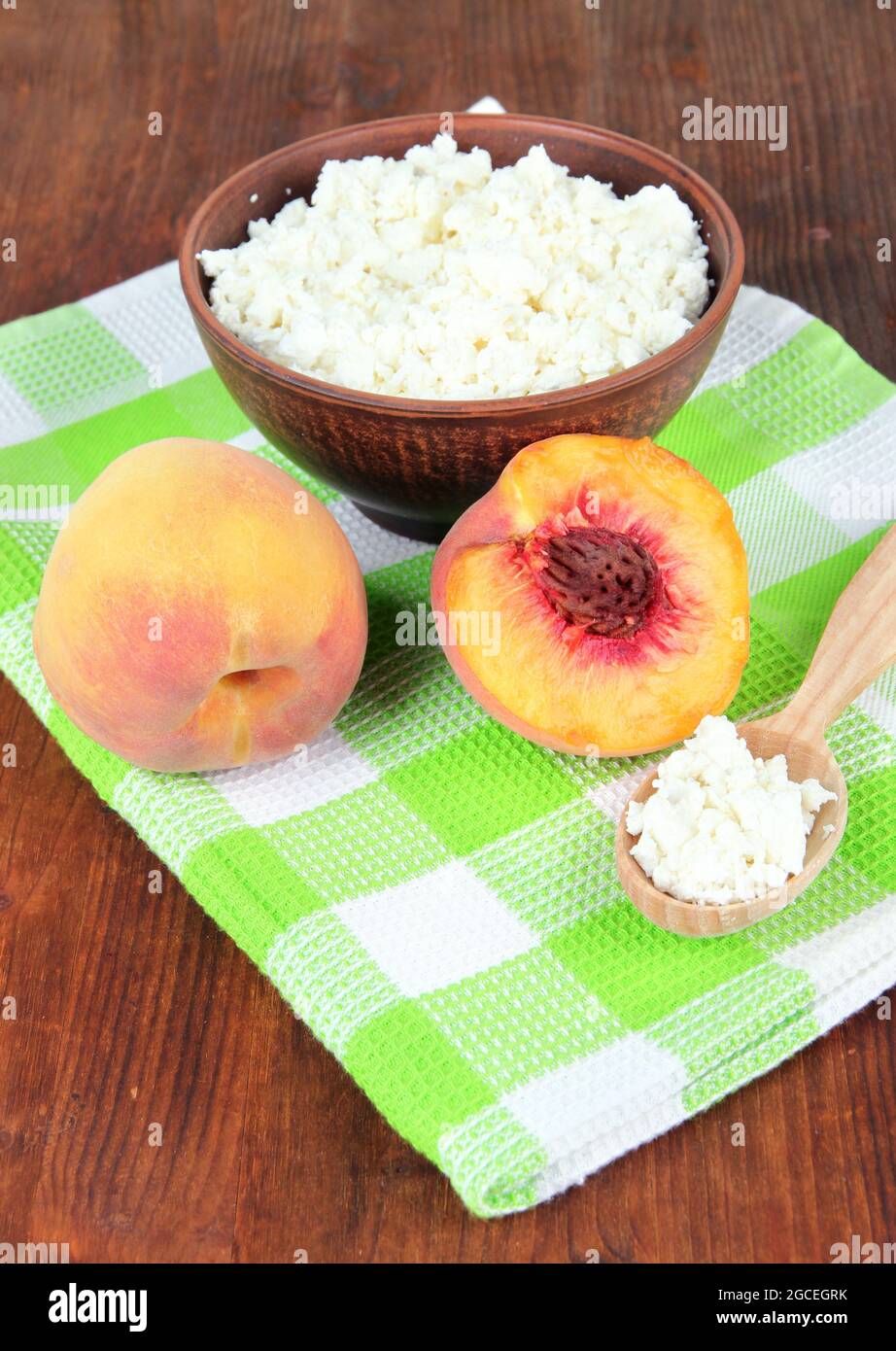 Sour cheese and fresh peaches,on wooden table background Stock Photo ...