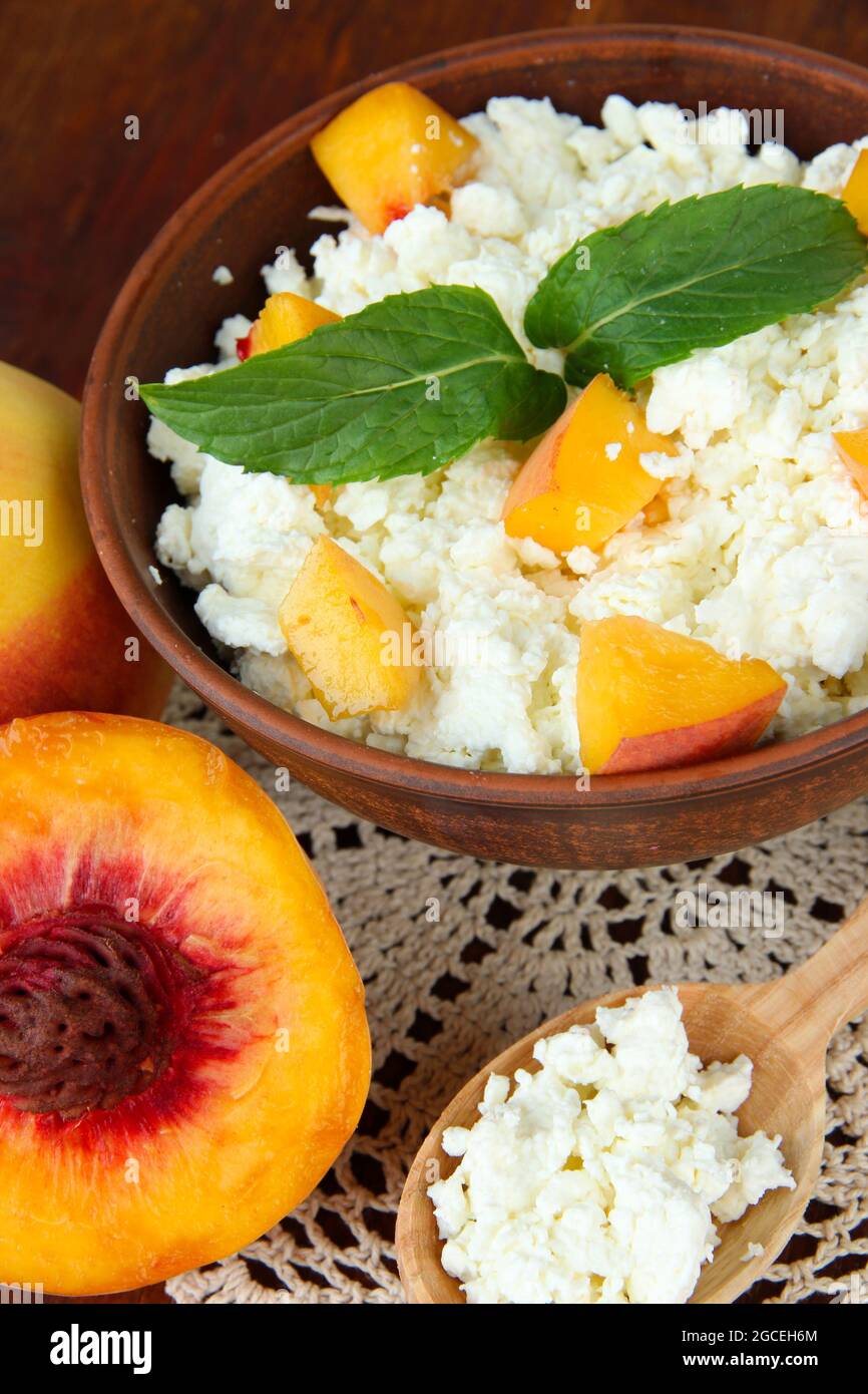 Sour cheese and fresh peaches,on wooden table background Stock Photo ...