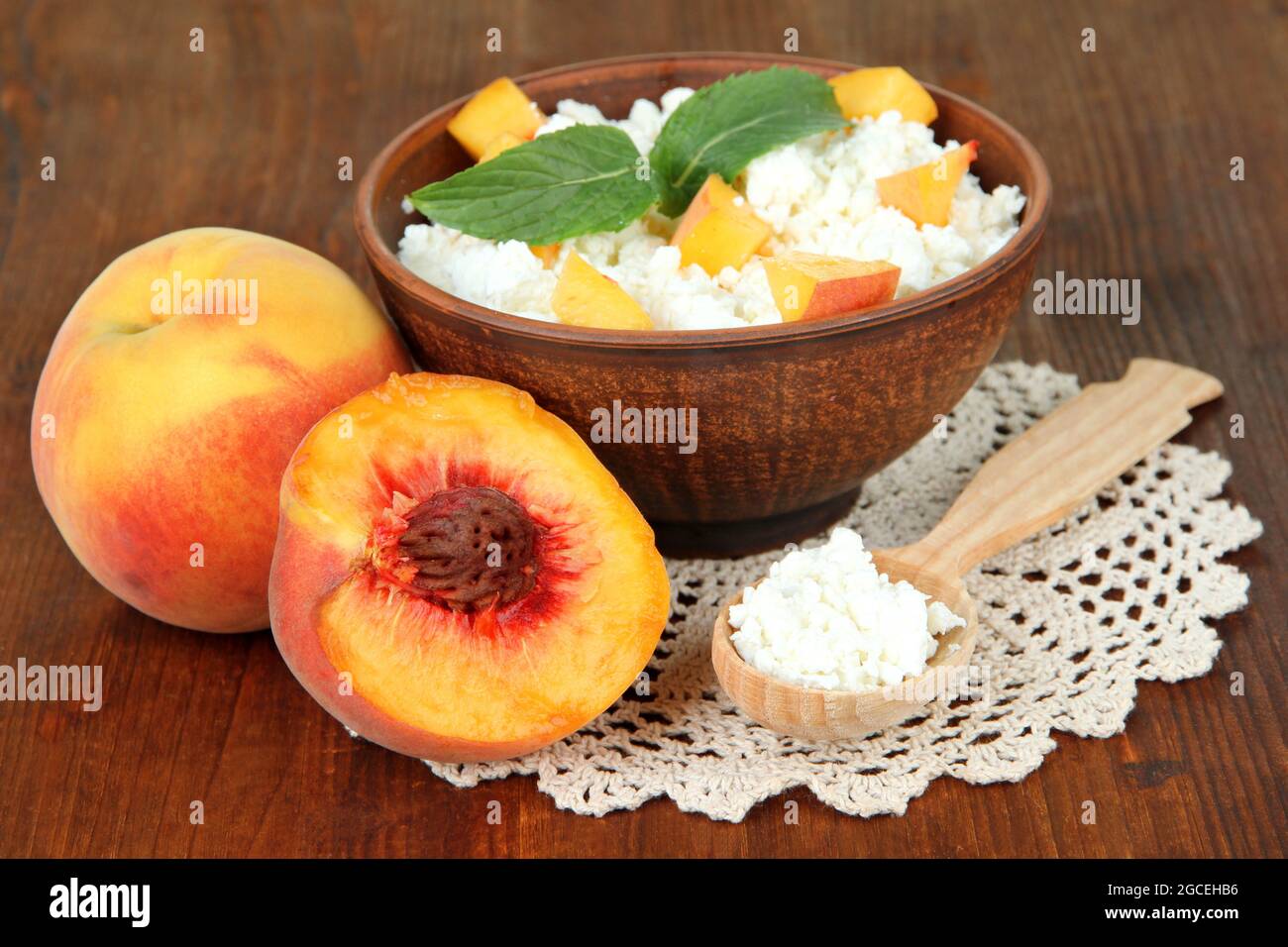 Sour cheese and fresh peaches,on wooden table background Stock Photo ...
