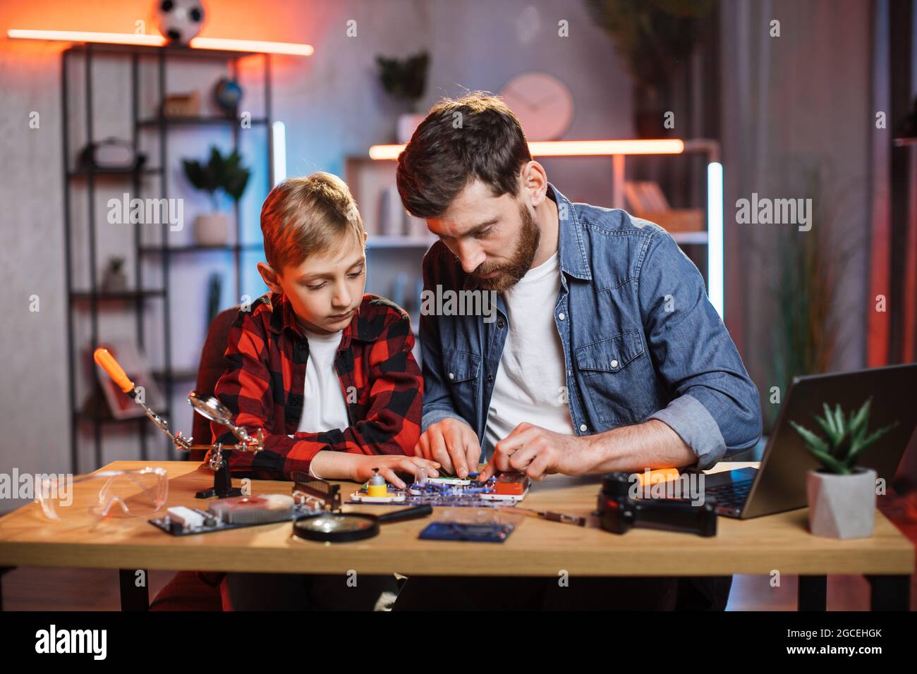 Handsome bearded man and little boy using child designer for making ...