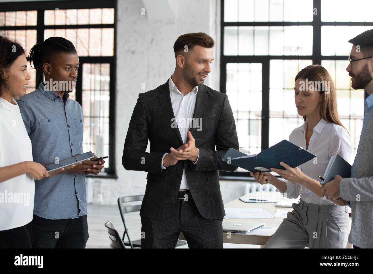 Diverse team coworkers analyzing business hi-res stock photography and ...