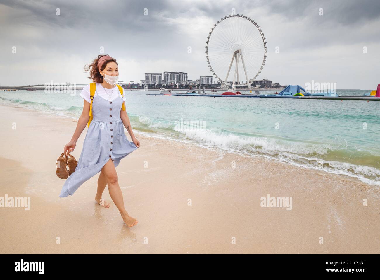 woman follows the rules and laws and wears a protective medical mask on ...