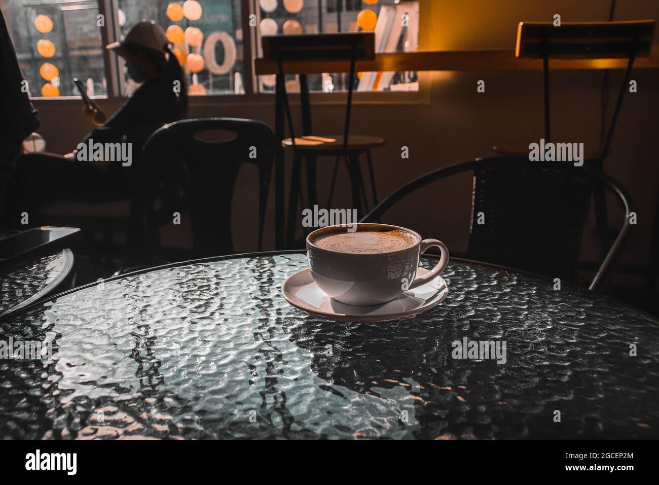 A woman sitting alone in a cafe, shows the concept of isolation, social ...