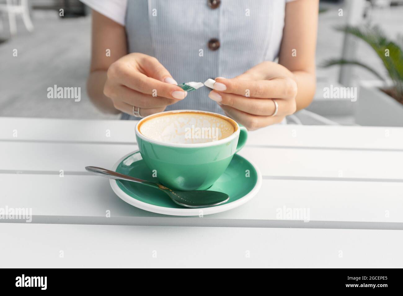 Woman finished her coffee and is going to chew gum to clean her teeth ...
