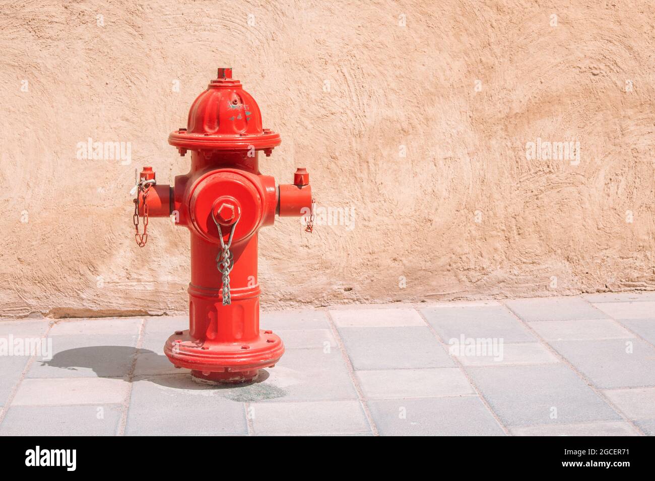 Red water fire hydrant on a pavement of city street. Firefighting and ...