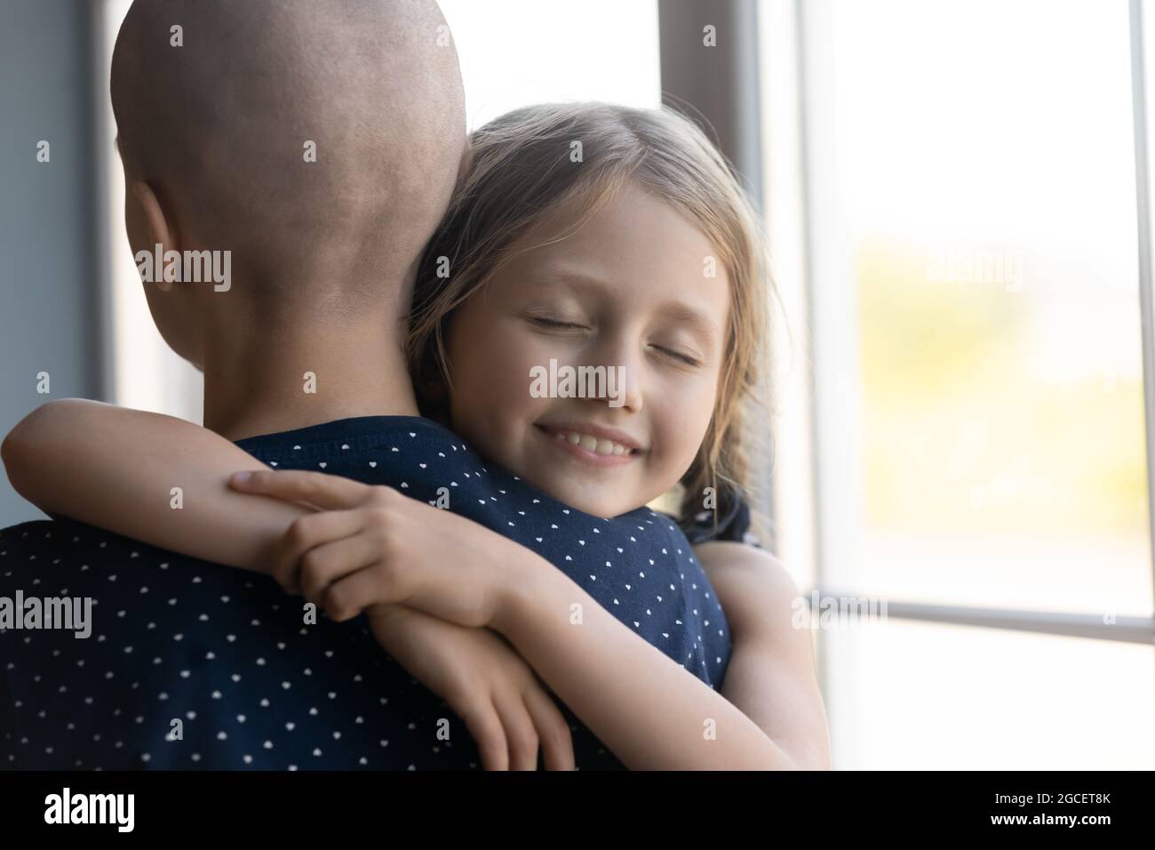 Happy daughter kid embracing cancer mom with closed eyes Stock Photo ...