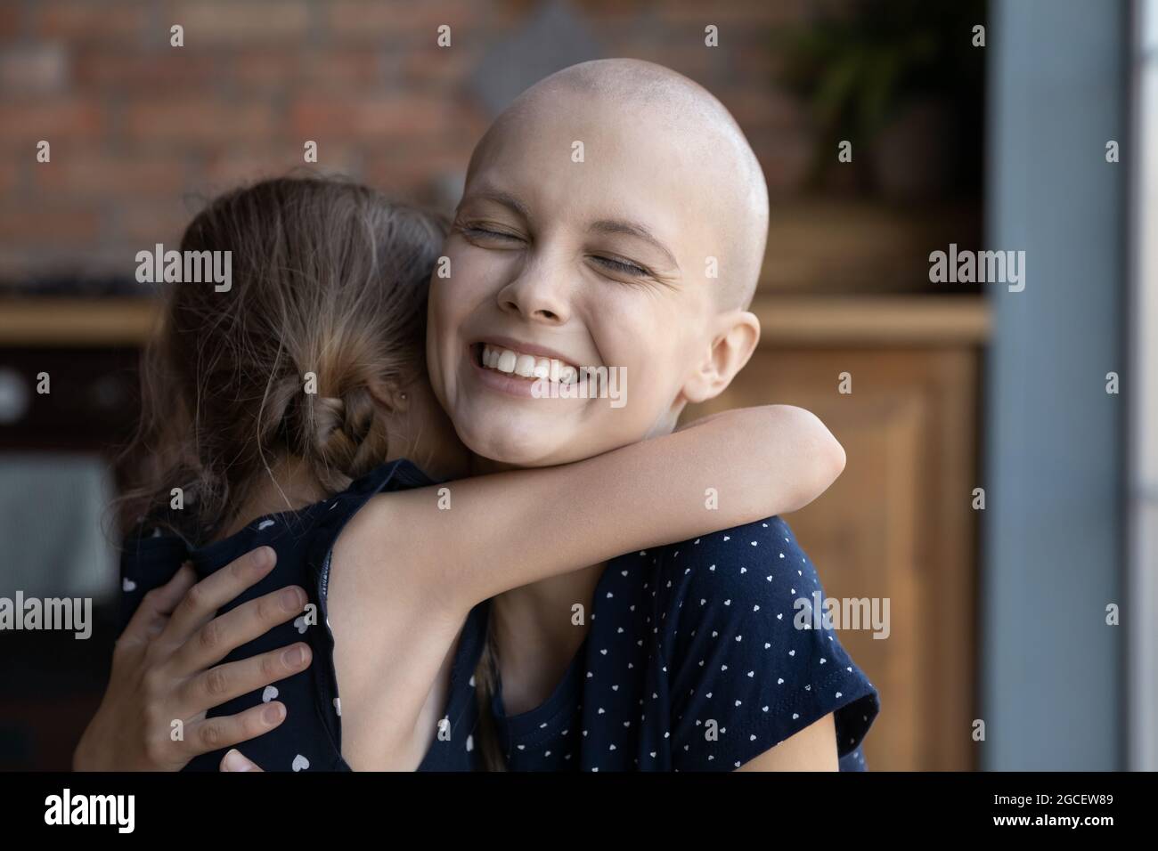 Happy excited young cancer mom embracing daughter kid Stock Photo - Alamy Happy excited young cancer mom embracing daughter kid Stock Photo - Alamy