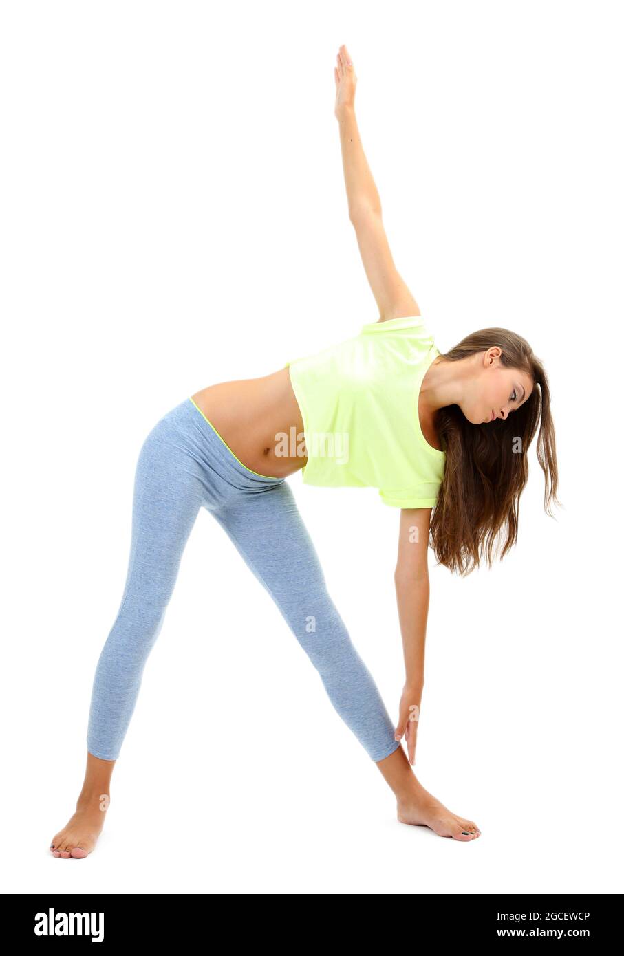 Young beautiful fitness girl doing yoga exercise isolated on white ...