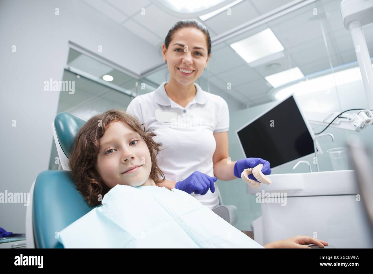 Happy young boy and cheerful female dentist smiling to the camera Stock ...