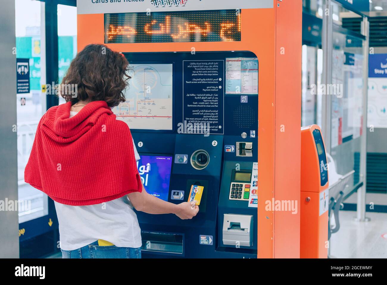 23 February 2021, Dubai, UAE: a female passenger replenishes her ...