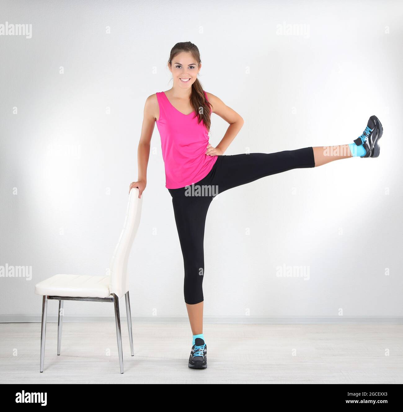Beautiful young girl doing exercises at home Stock Photo - Alamy