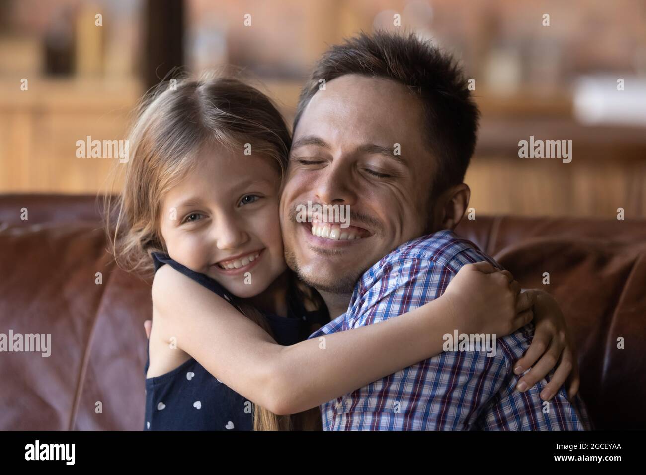 Happy daddy and little daughter girl hugging cheek to cheek Stock Photo ...