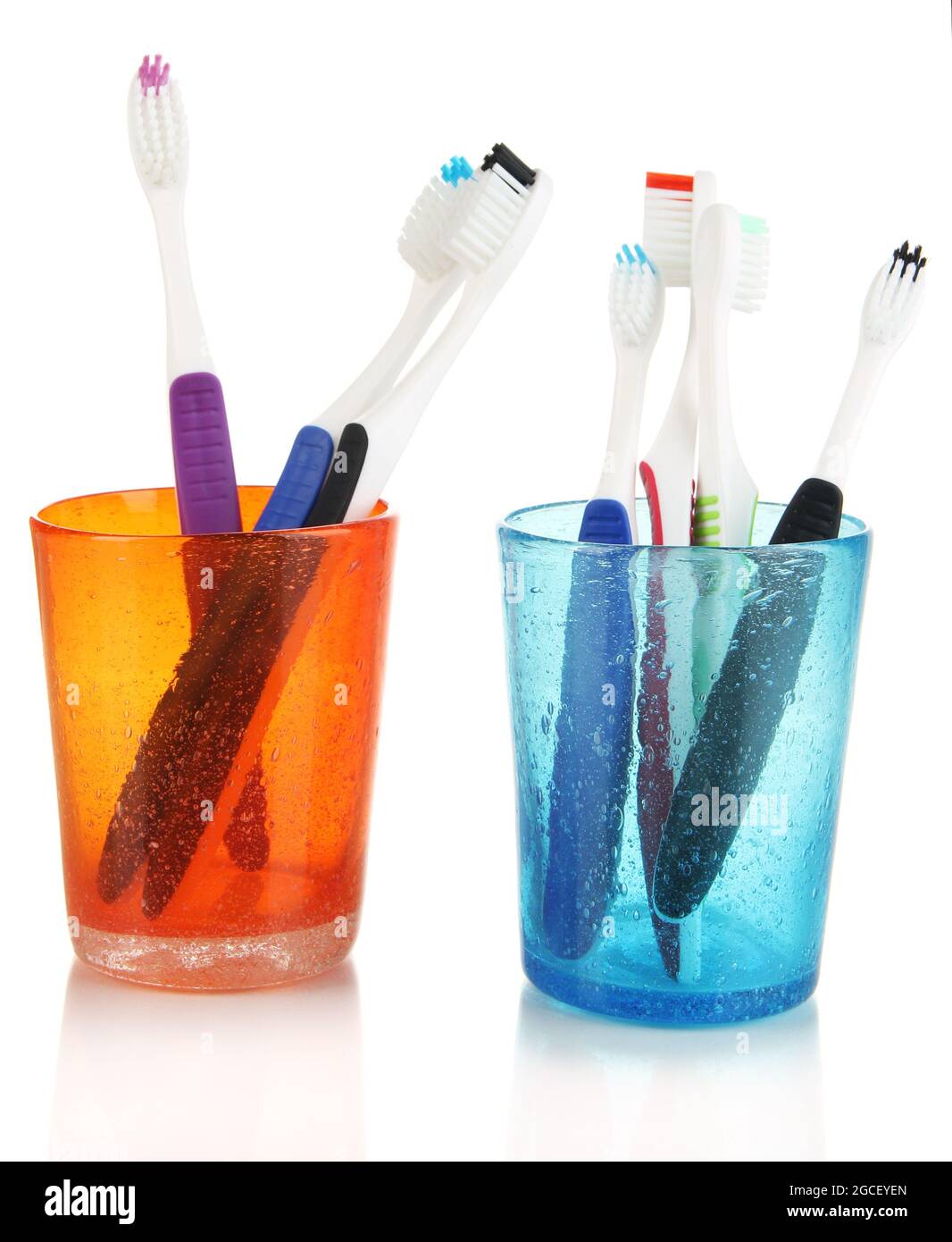 Tooth-brushes in glass isolated on white Stock Photo - Alamy