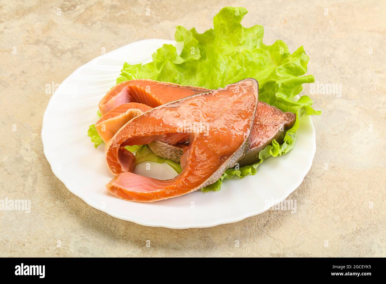 Two pink salmon fish steak served salad leaves Stock Photo - Alamy