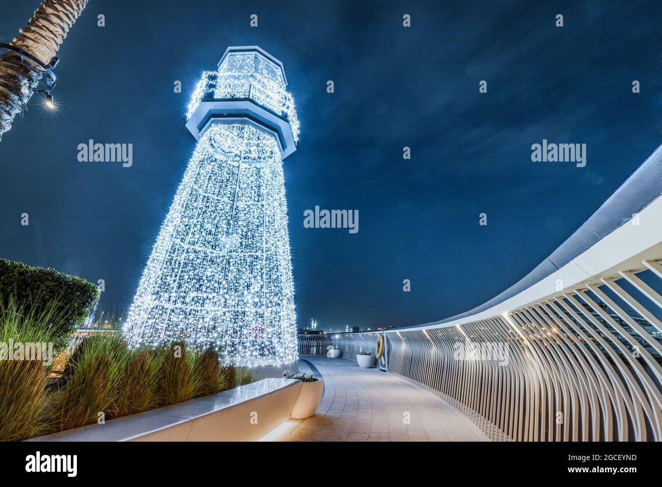 Illuminated decorative lighthouse near the parking lot of yachts and ...