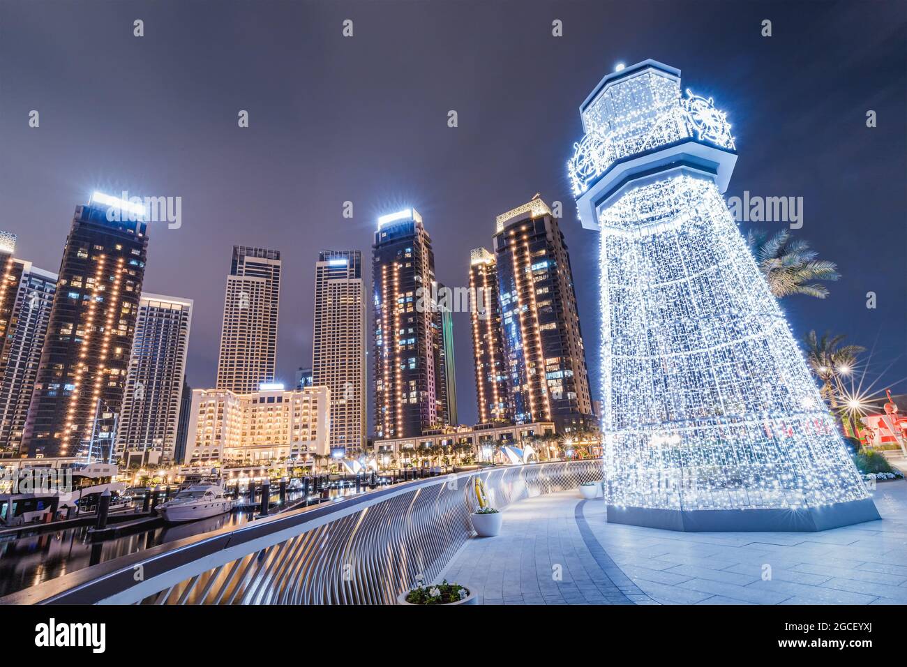 Illuminated decorative lighthouse near the parking lot of yachts and ...