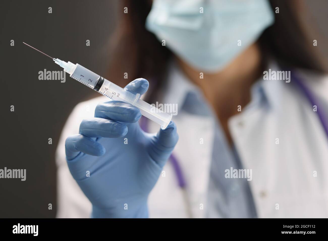 Doctor hand holds syringe hi-res stock photography and images - Alamy