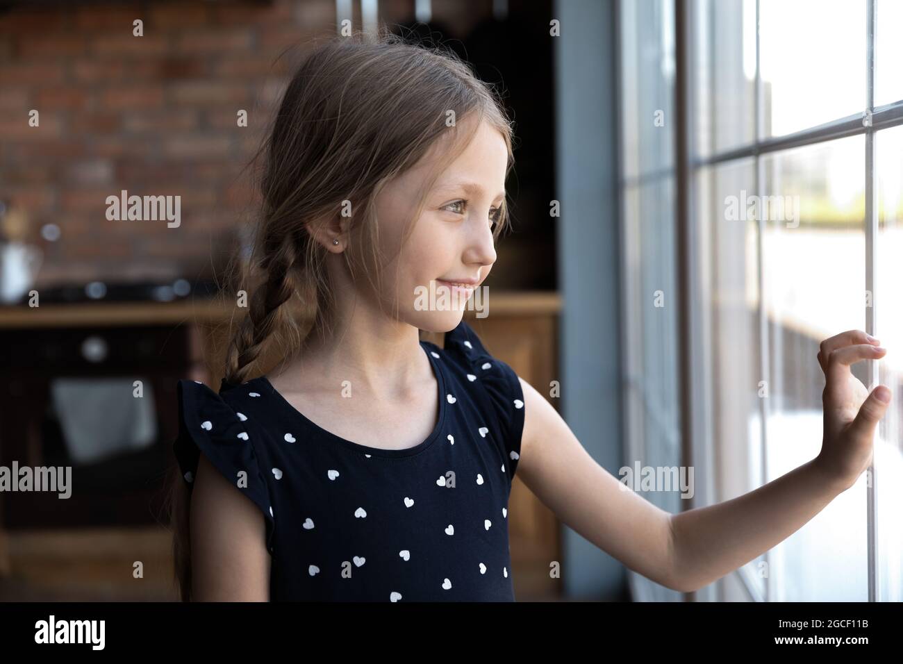Happy kid looking out window, touching glass Stock Photo - Alamy