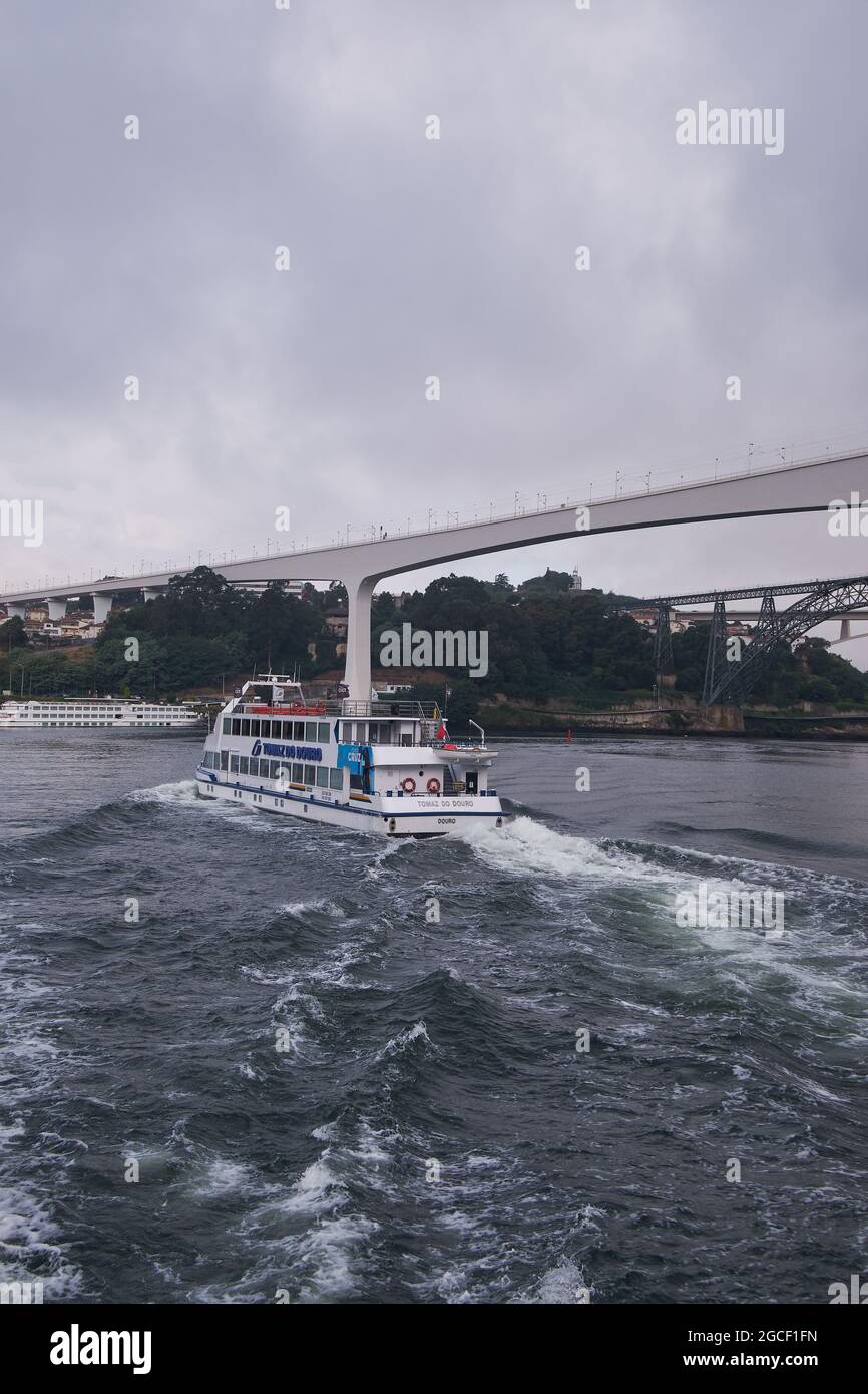 Cruise Boat in Douro River below Concrete Freixo Bridge on a Cloudy ...