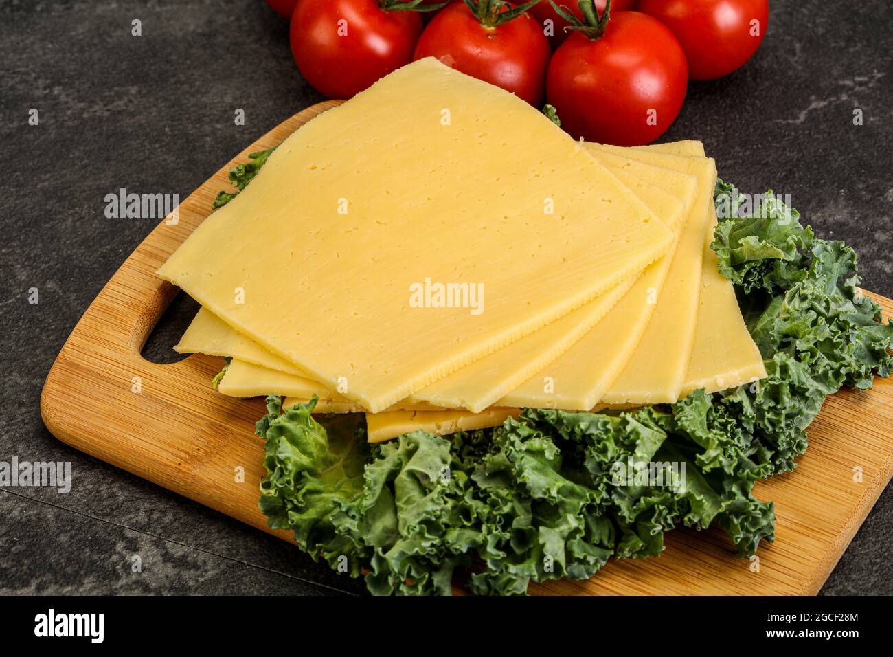 Sliced Gauda cheese snack over board Stock Photo - Alamy