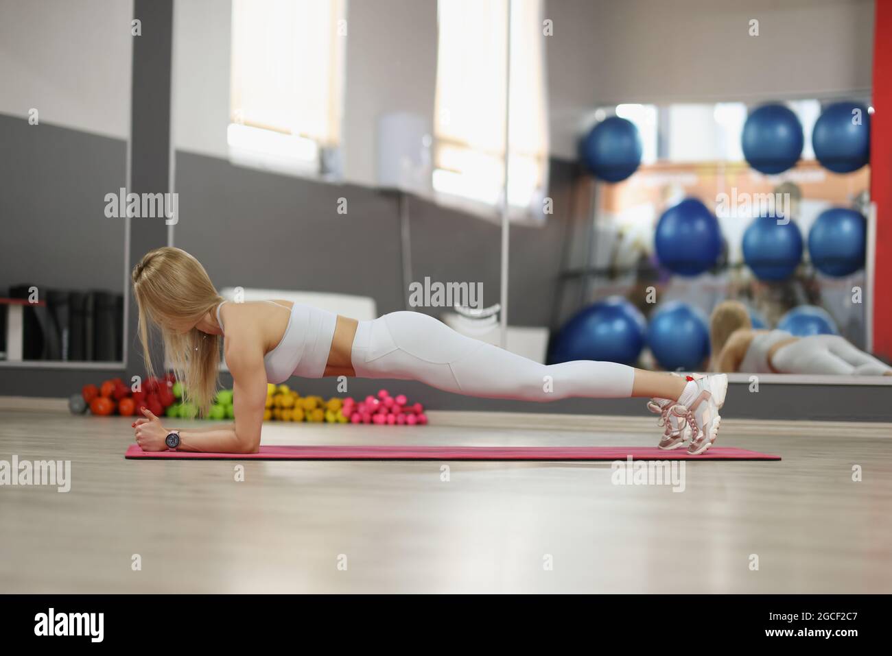 Strong beautiful girl in sportswear doing plank exercise closeup Stock ...