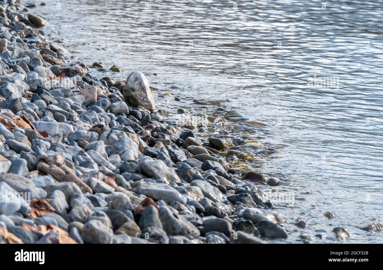 Pebble stones on the shore close up Stock Photo - Alamy