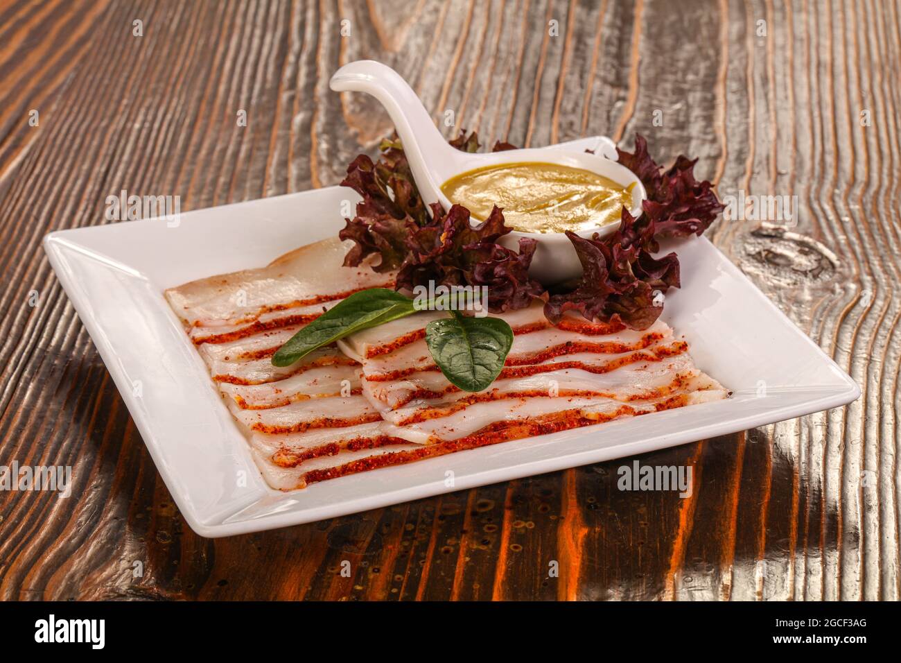 Sliced pork fat with mustard sauce Stock Photo - Alamy