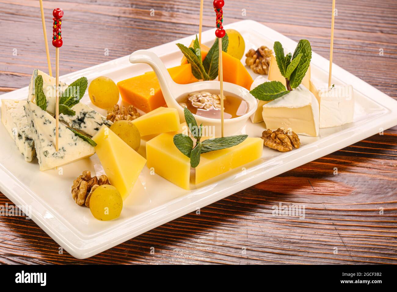 Cheese plate mix with honey and nuts Stock Photo - Alamy