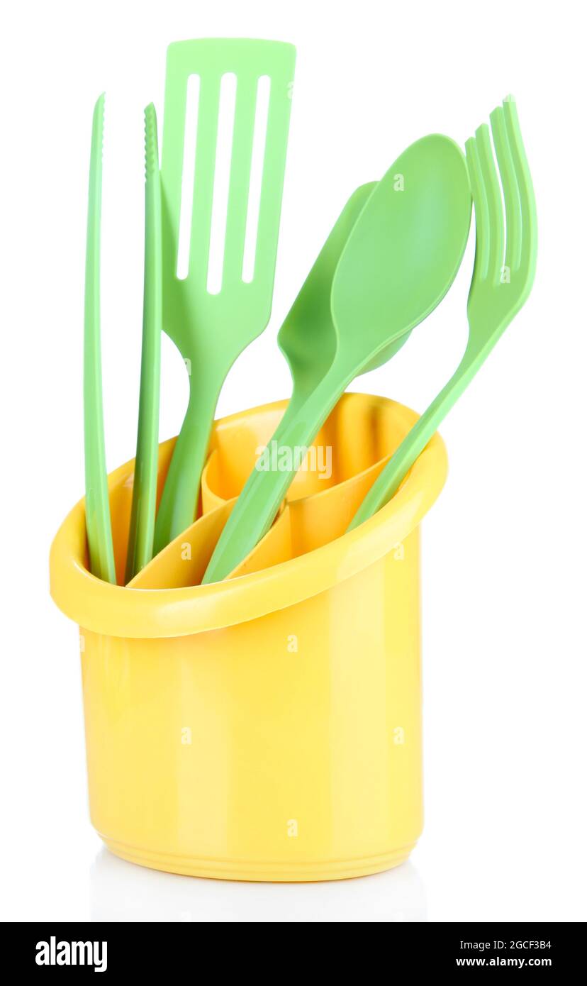 Plastic kitchen utensils in cup isolated on white Stock Photo - Alamy