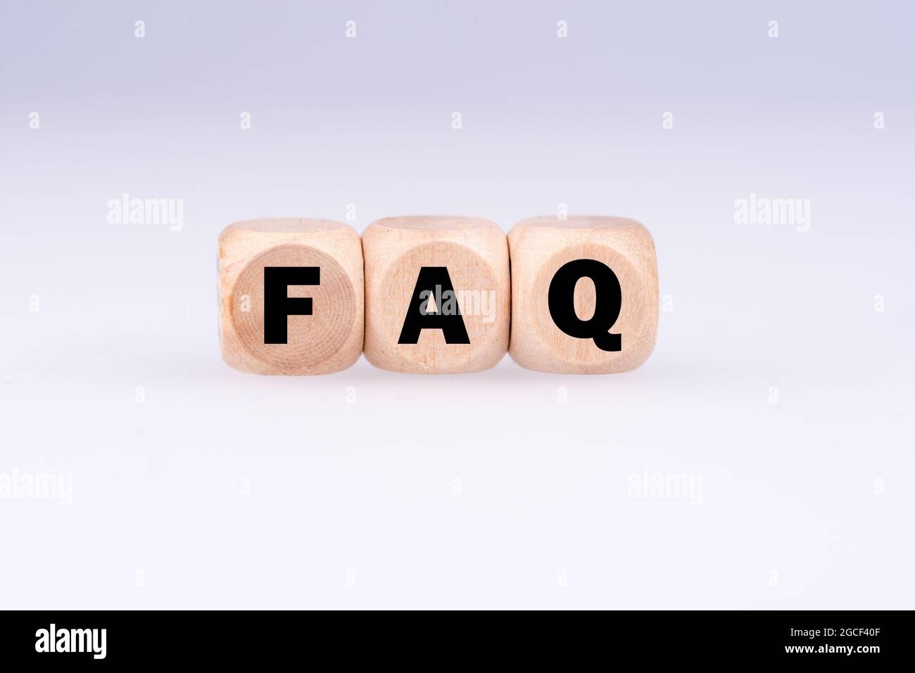 An illustration of three dice placed to make "FAQ" text on an isolated ...