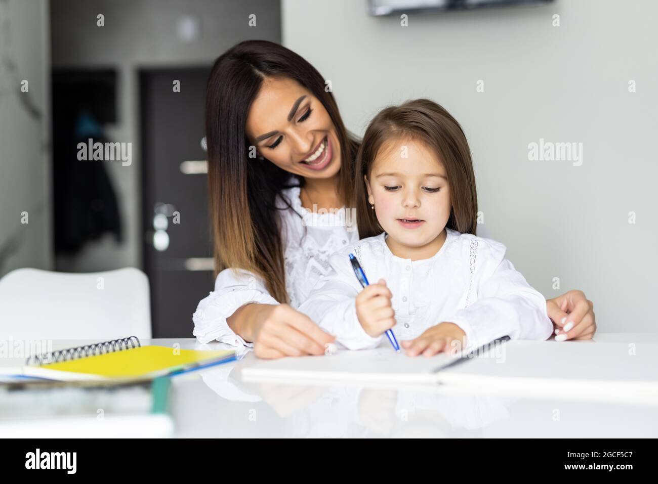 Parent helps the child to do homework. Mother learning her daughter ...