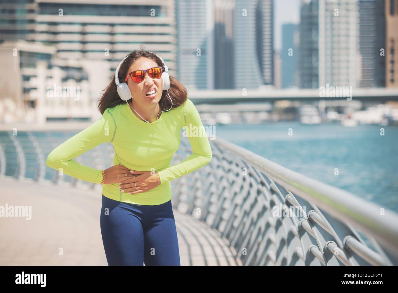 Suffering woman on a jog is experiencing severe pain in her side ...