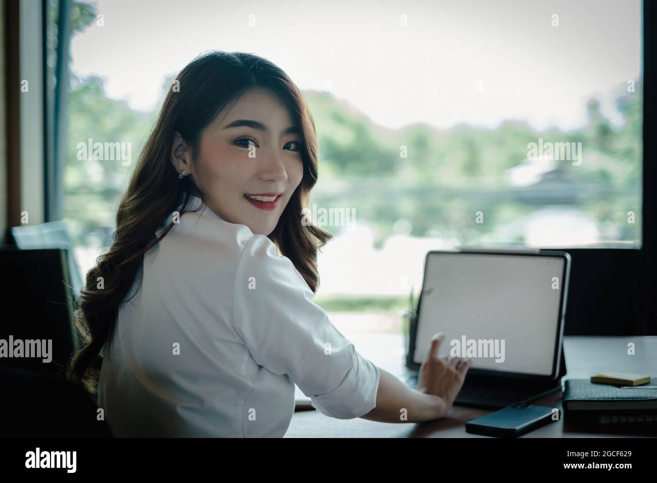 business woman sitting in office with laptop computer on desk Stock ...