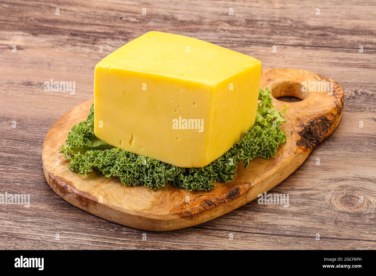 Yellow tilsiter cheese dairy product brick Stock Photo - Alamy