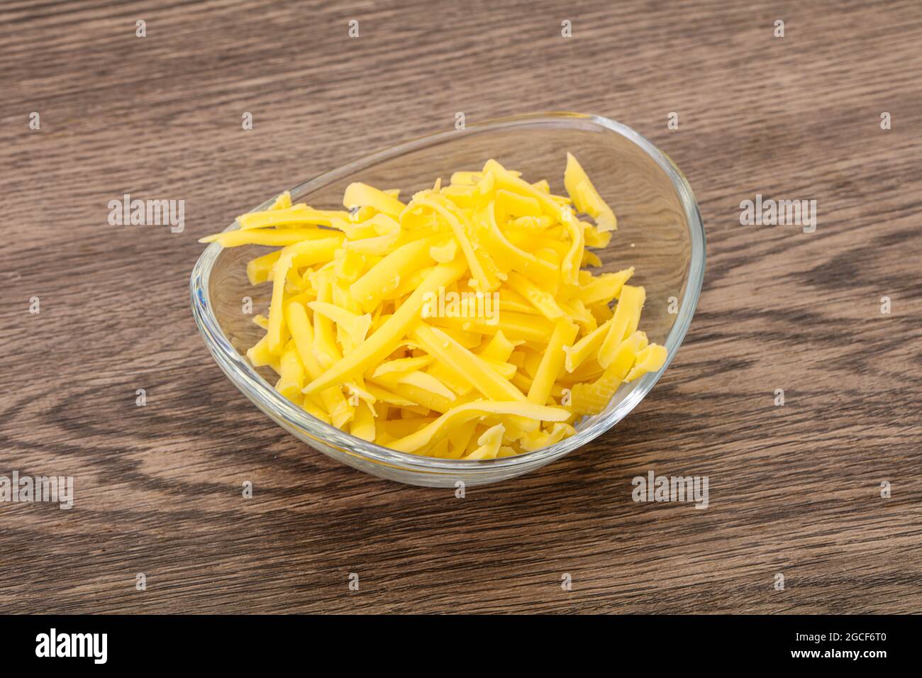 Shredded yellow cheese in the bowl for cooking Stock Photo - Alamy